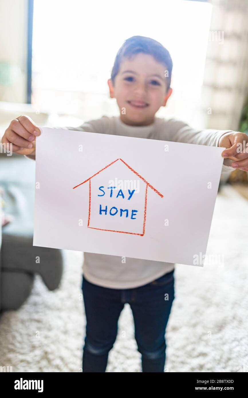 Little kid with Stay Home draw. Coronavirus concept Stock Photo - Alamy