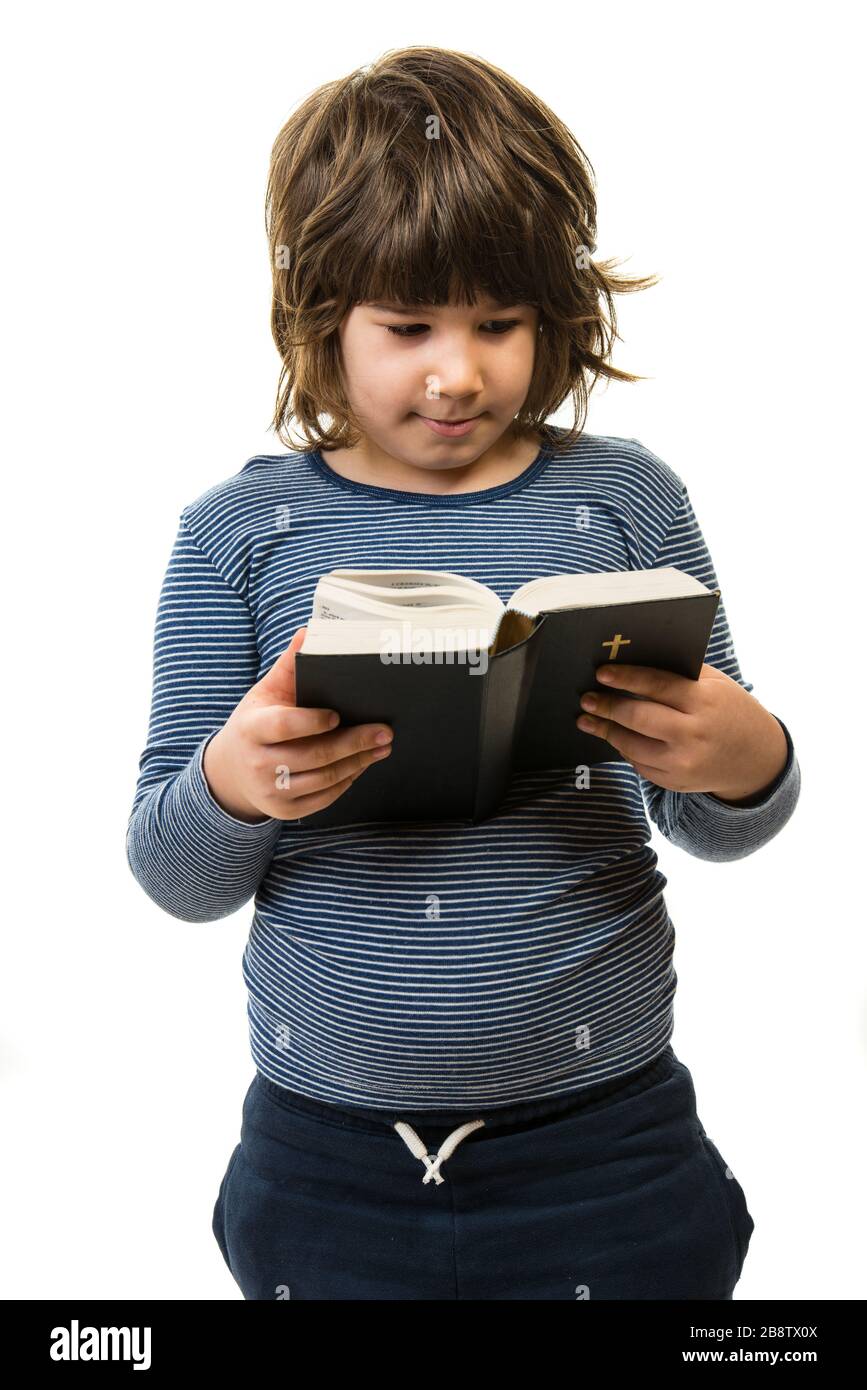 Little boy reading bible isolated on white background Stock Photo - Alamy
