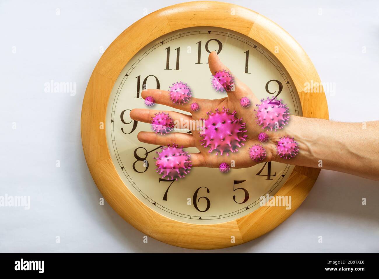 COVID-19 virus cells on hand with a clock on background. Conceptual: no ...
