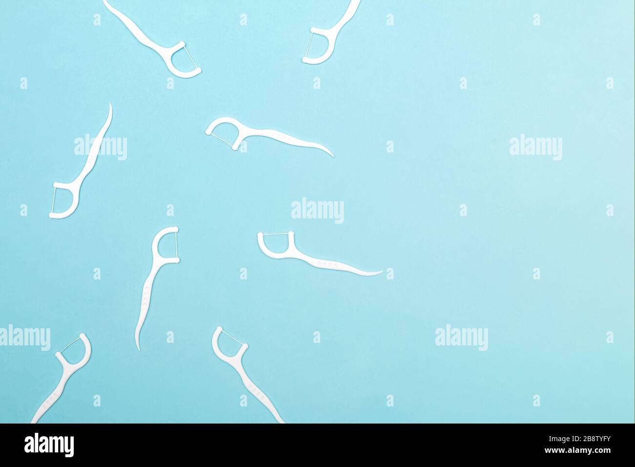 Many dental floss picks on blue color background, top view Stock Photo ...