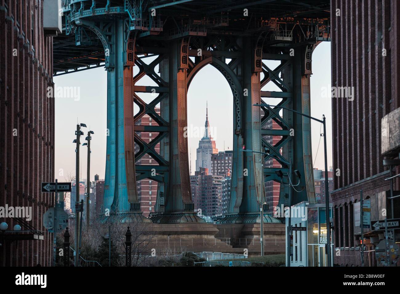 Empire State Building Shot Through The Brooklyn Bridge Stock Photo - Alamy