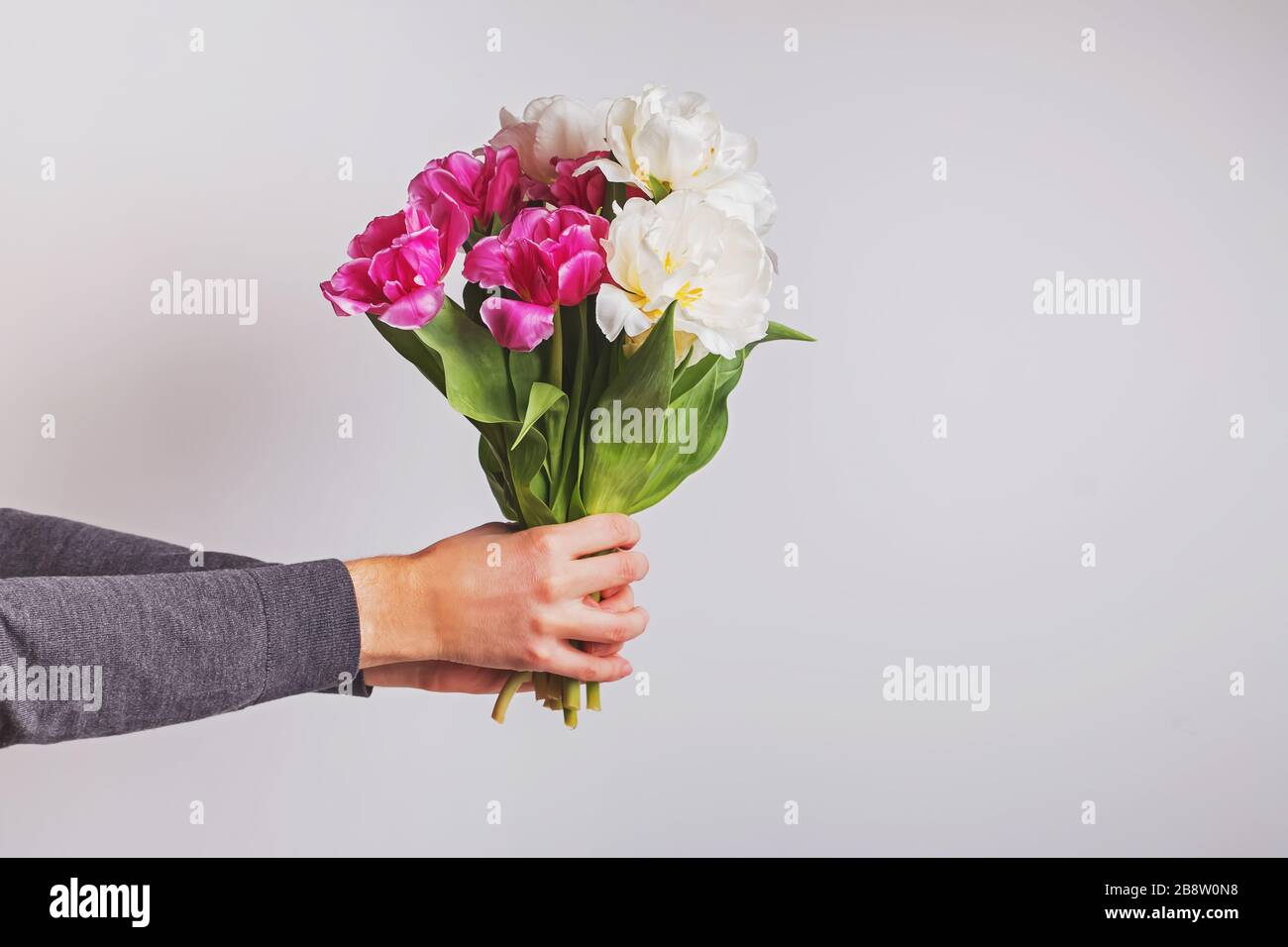 Hand man holding flowers flower hi-res stock photography and images - Alamy