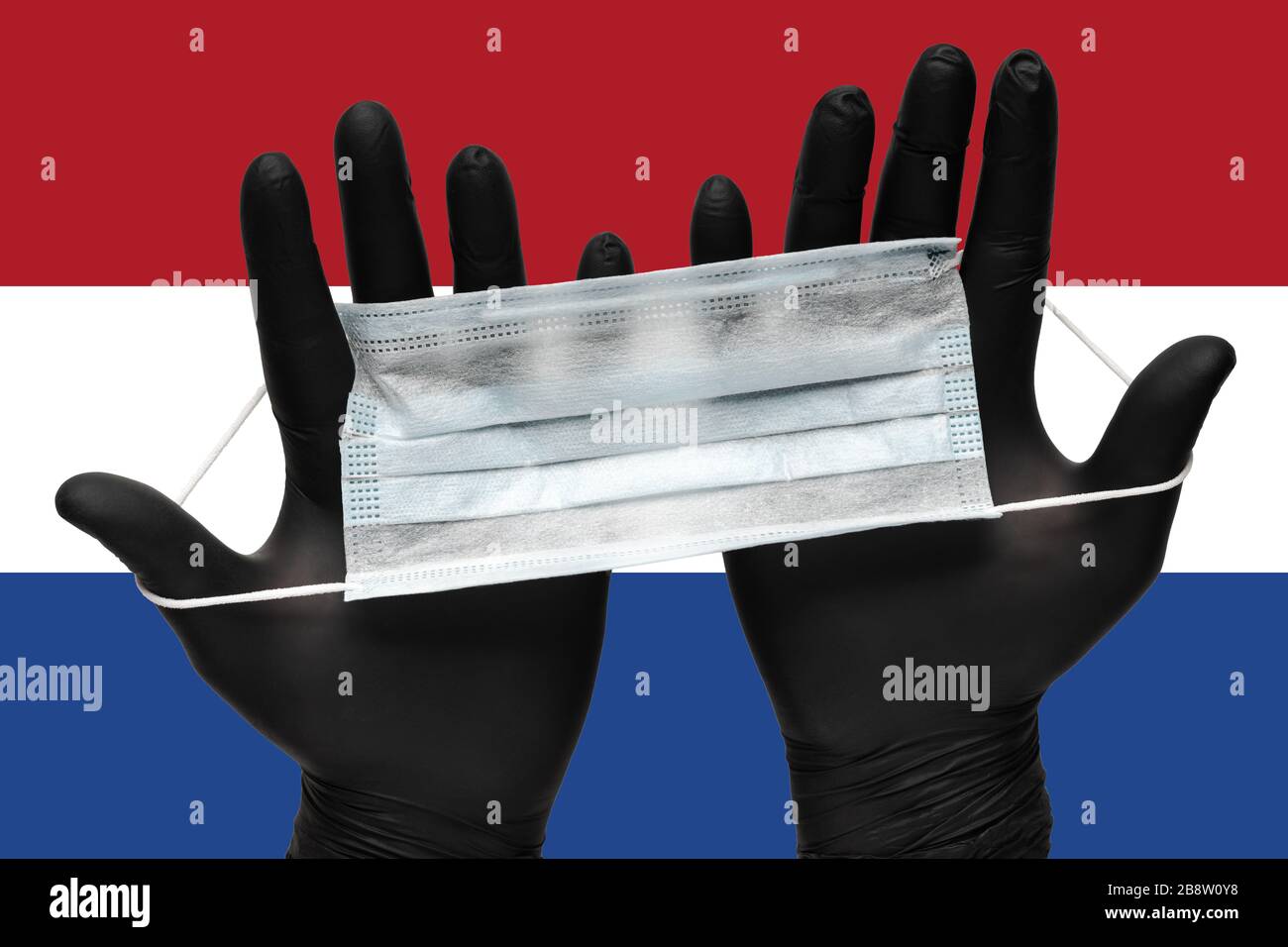 Doctor holds face mask in hands in black medical gloves on background ...