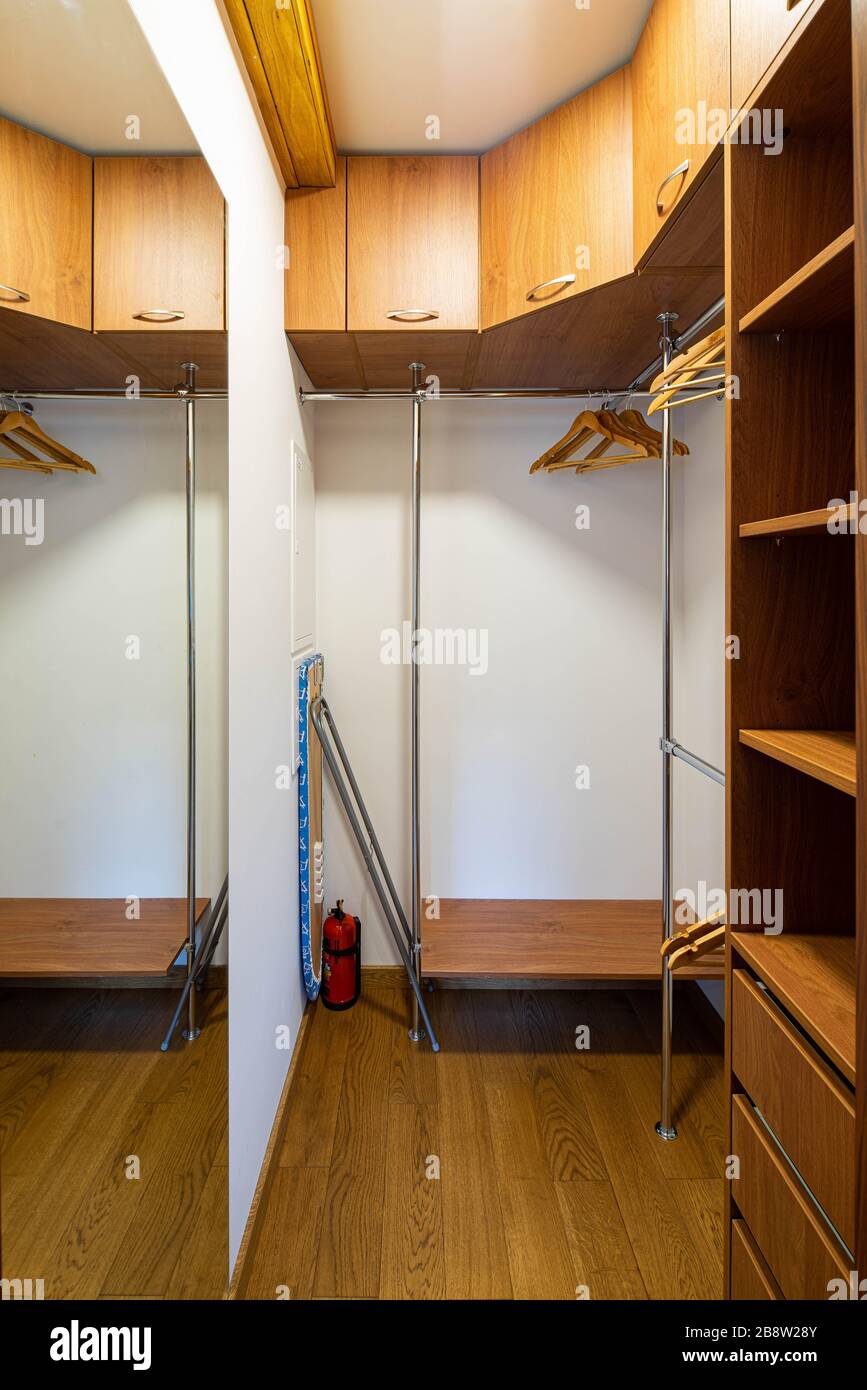 Modern interior of empty dressing room. Wooden shelves and drawers ...