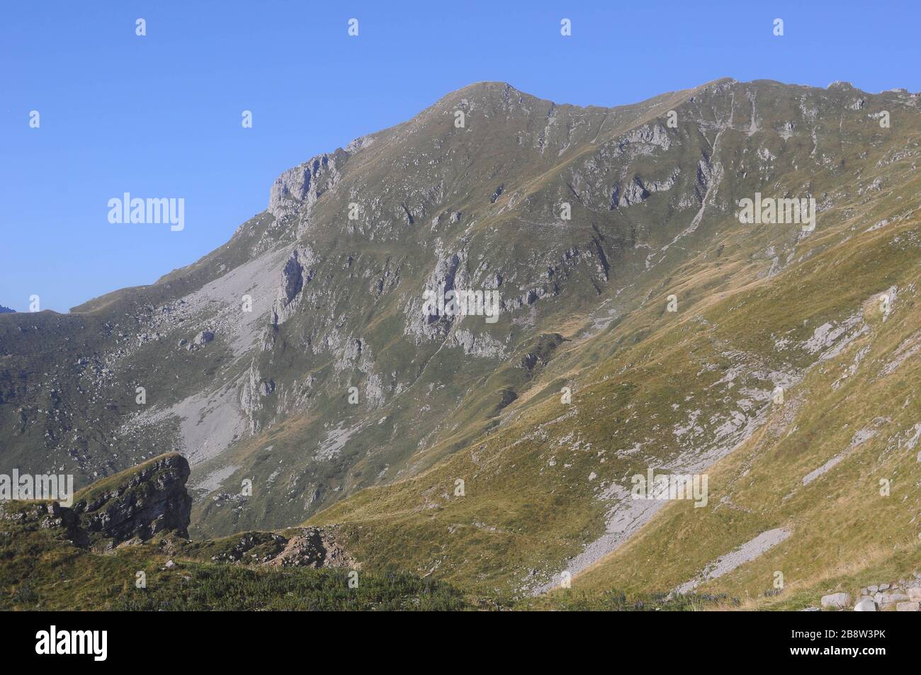 a mountain with green pastures heated by the summer sun Stock Photo - Alamy