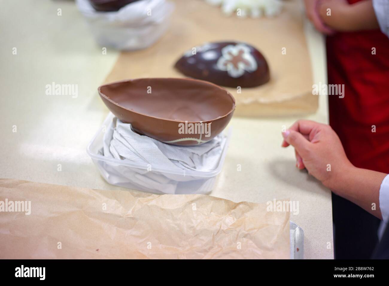 Making chocolate. Making chocolate easter eggs. Chocolate factory Stock ...