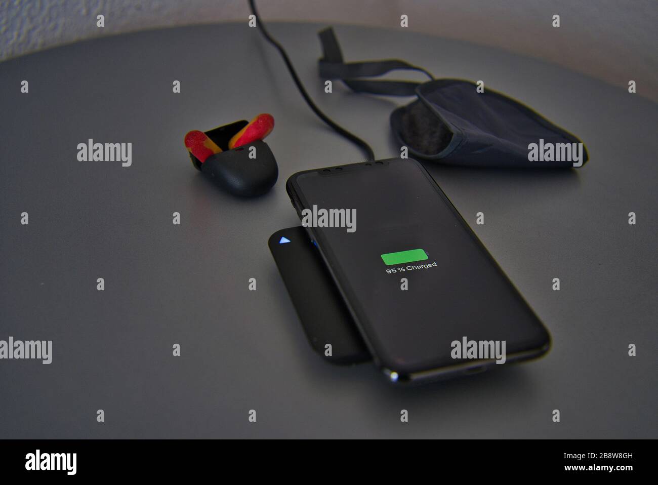 Black desktop wireless charger with charging led charging a smartphone ...