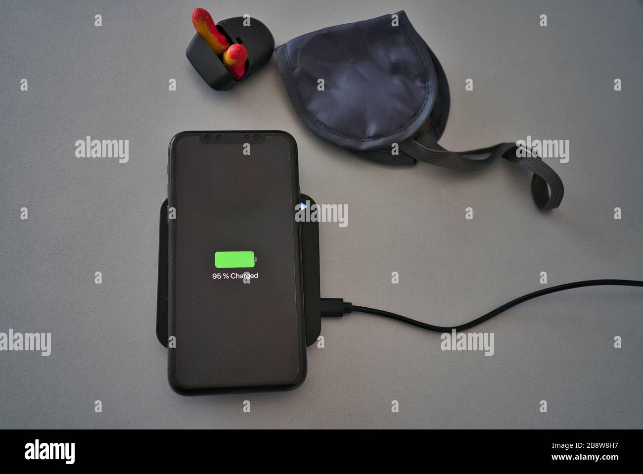 Black desktop wireless charger with charging led charging a smartphone ...