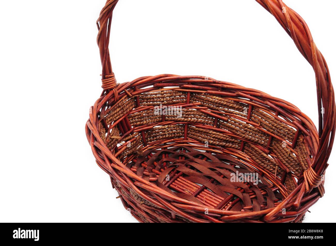 Straw basket on an isolated white background Stock Photo - Alamy