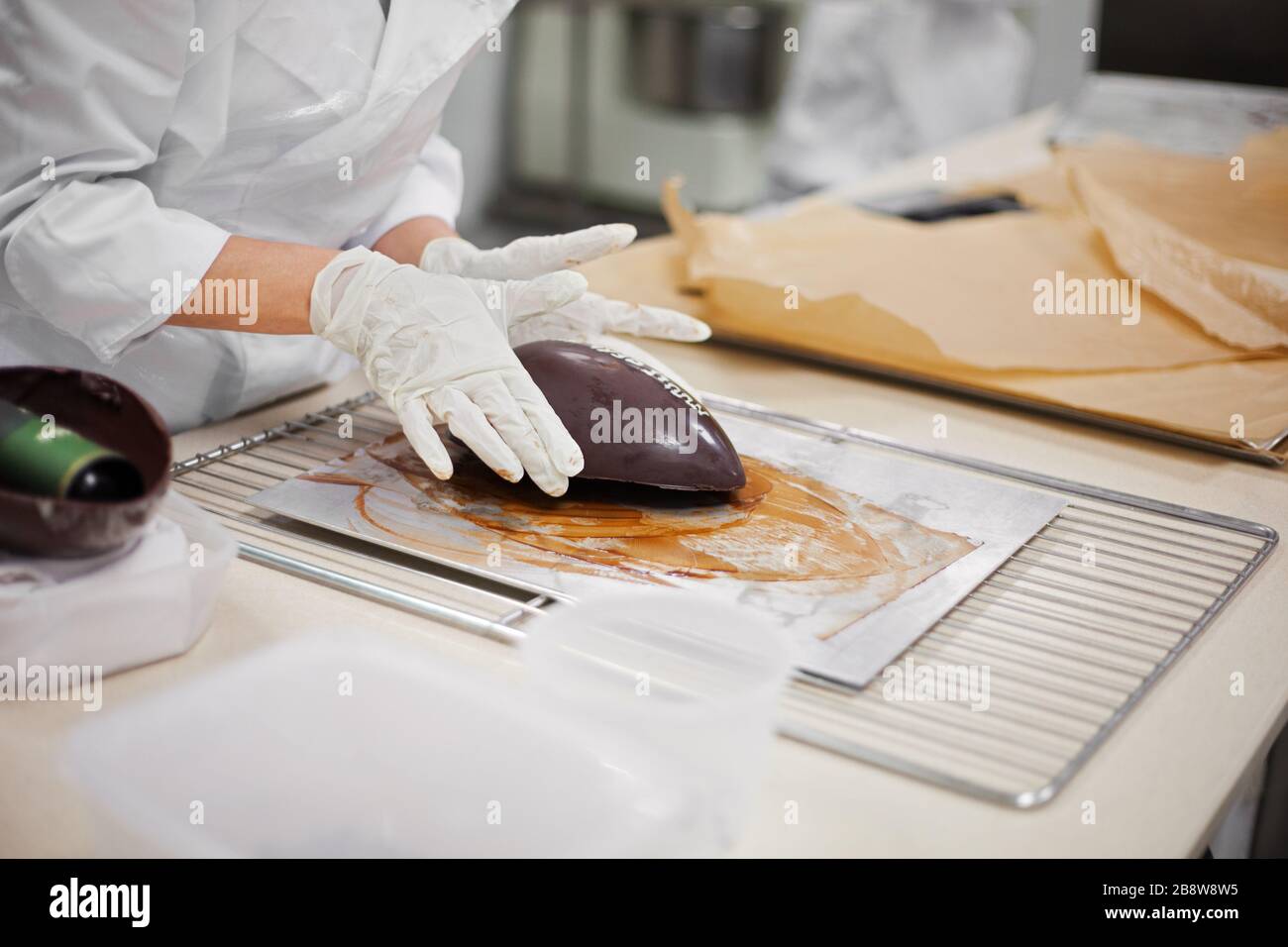 Making chocolate. Making chocolate easter eggs. Chocolate factory Stock ...