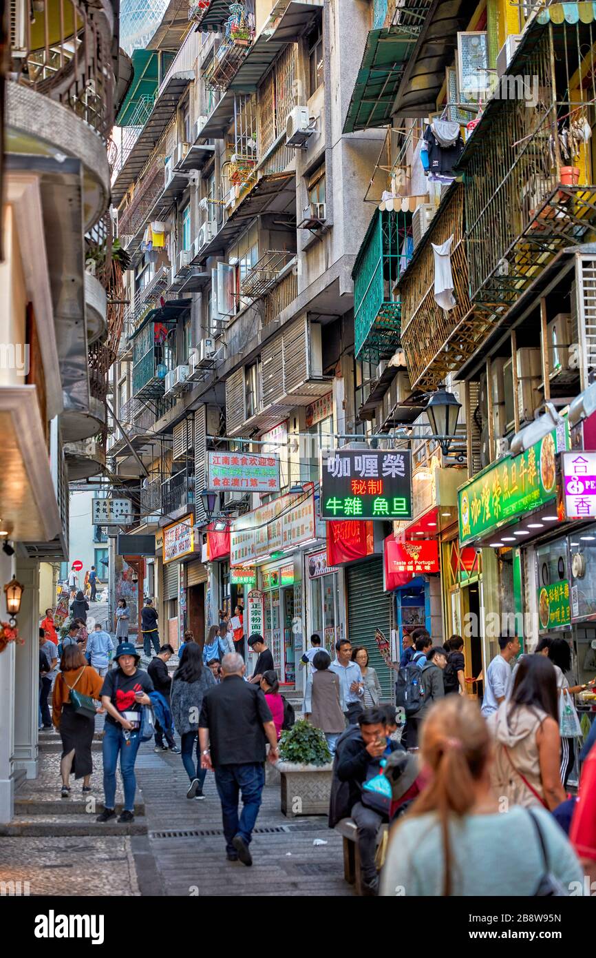 People walking on the narrow street in the historic center. Macau ...