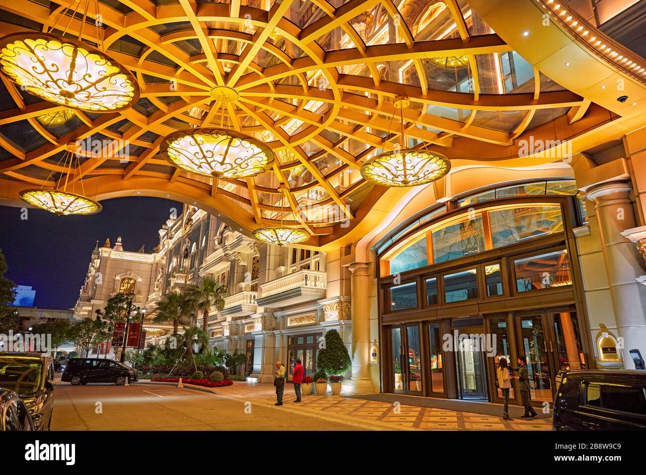 Main entrance to the Ritz-Carlton Hotel illuminated at night. Cotai ...