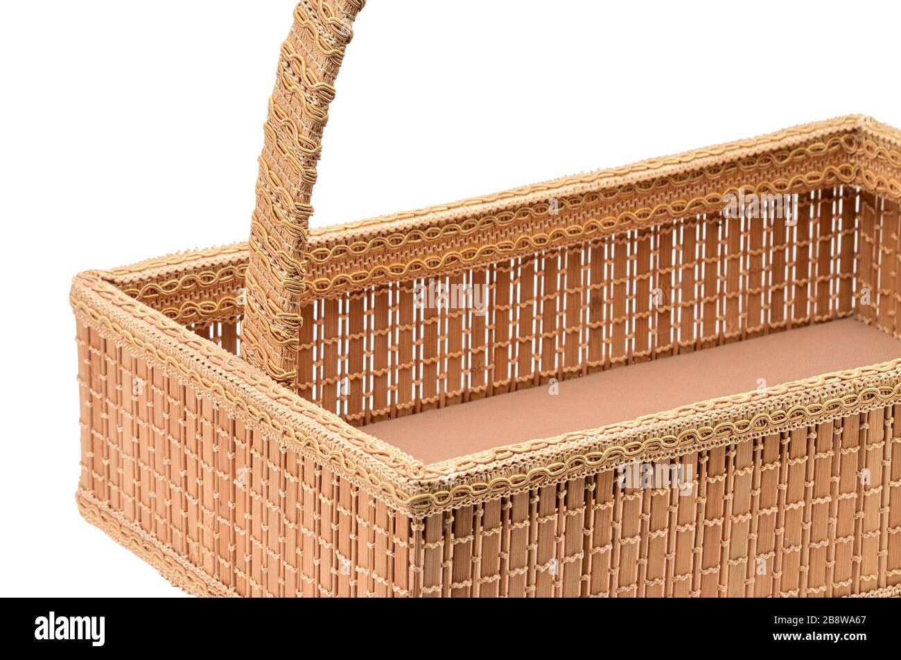 Straw basket on an isolated white background Stock Photo - Alamy