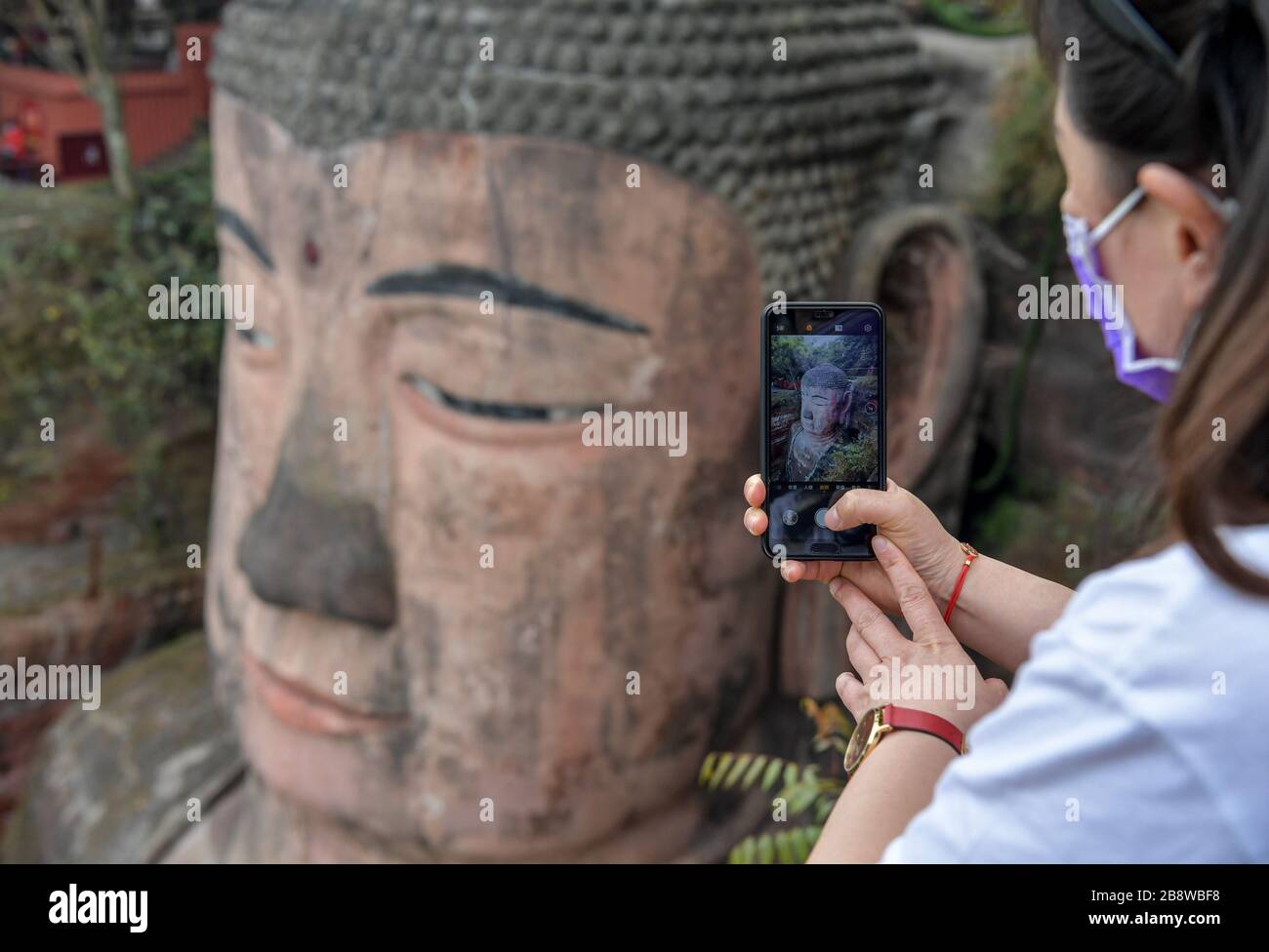 Leshan, China's Sichuan Province. 23rd Mar, 2020. A tourist takes ...