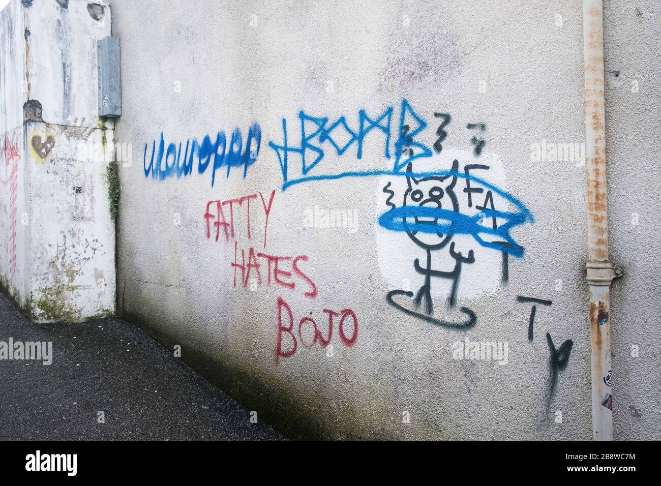 Ugly graffiti sprayed on a wall in Truro City centre in Cornwall Stock ...