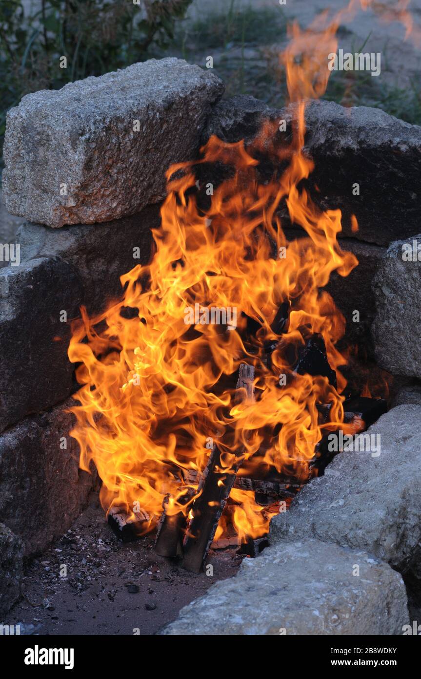 Campfire fire kindled in a camping trip Stock Photo - Alamy