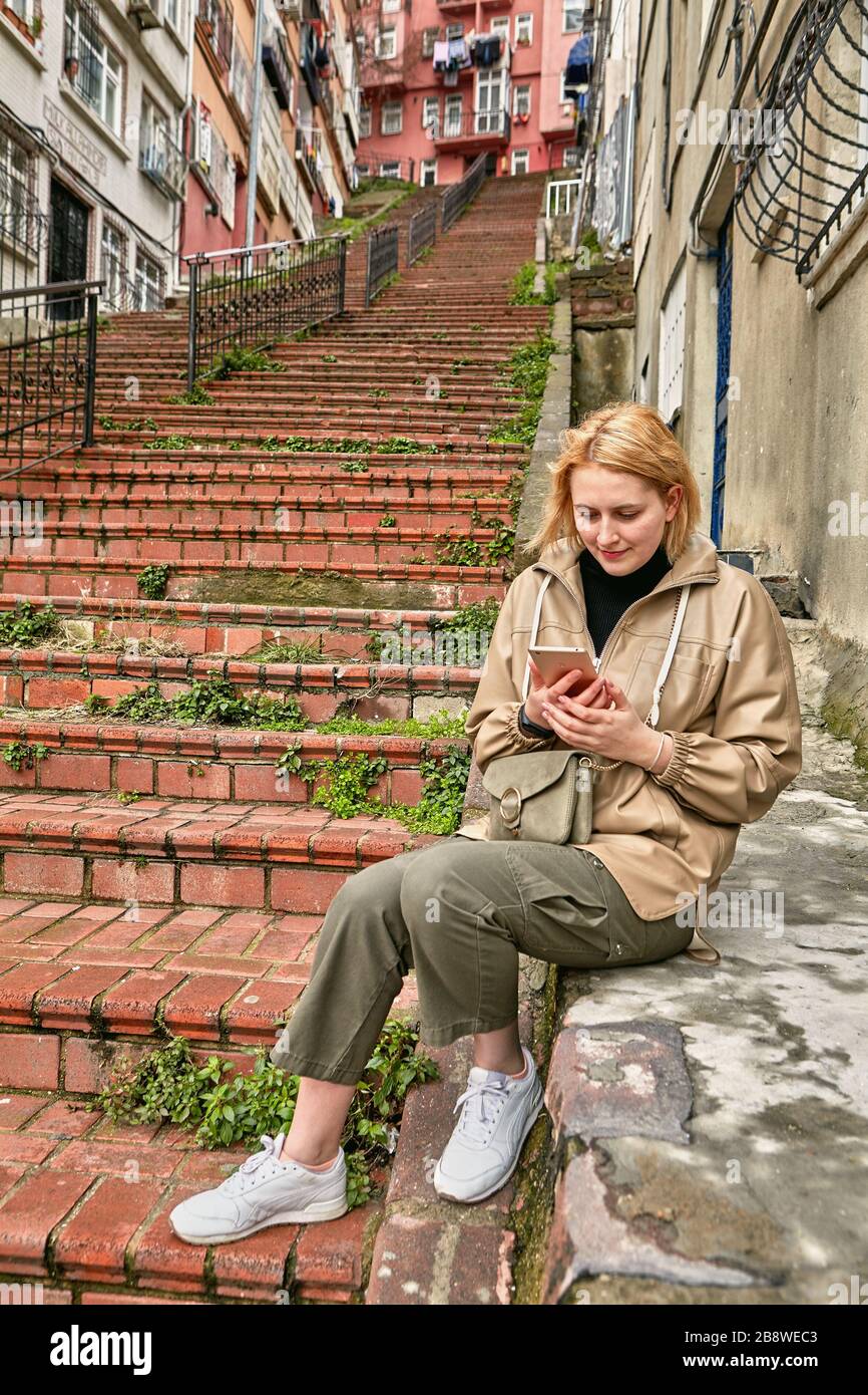 A Young Caucasian Woman Travels Around Istanbul She Looks At A Map In a-young-caucasian-woman-travels-around-istanbul-she-looks-at-a-map-in