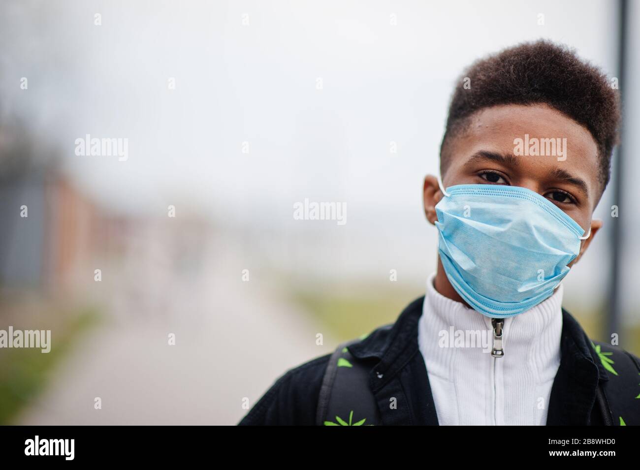 African man at park wearing medical masks protect from infections and ...