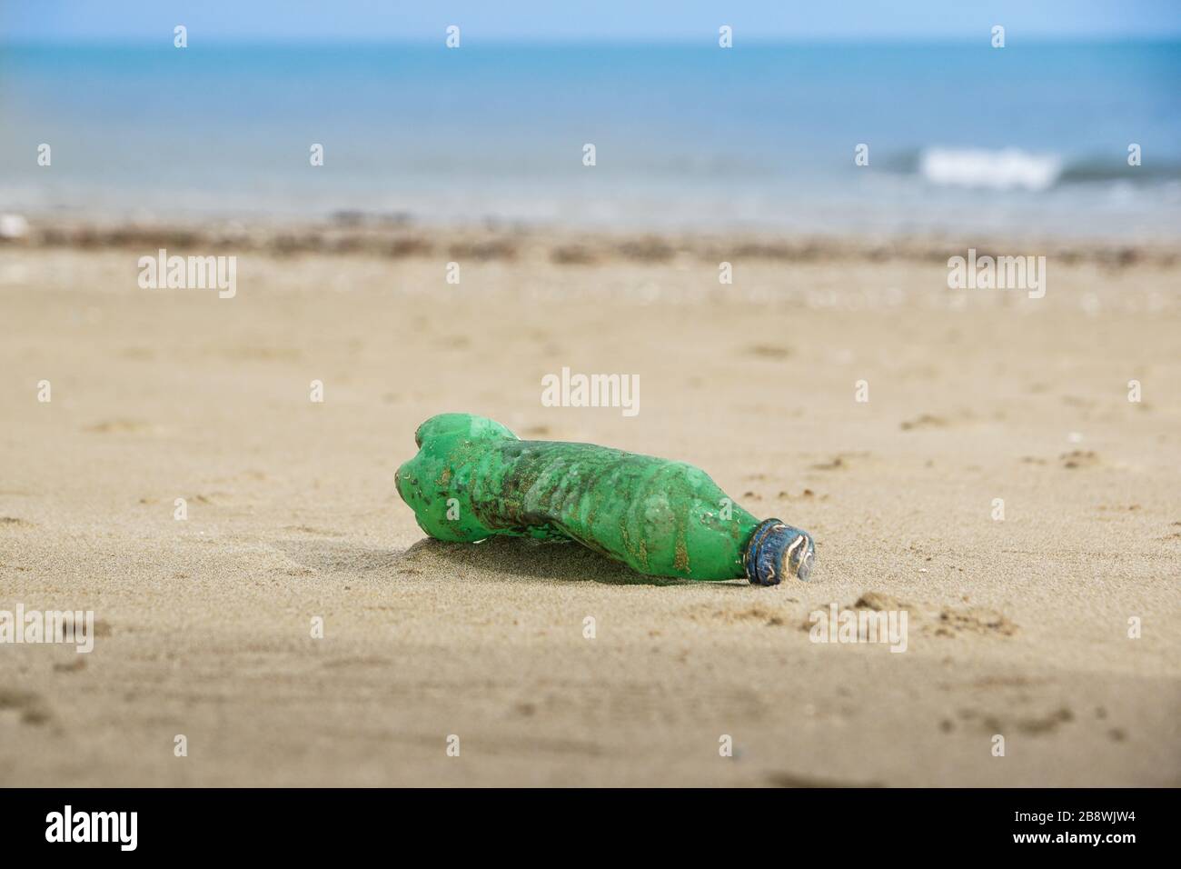 Waste plastic bottle on sand. Garbage on the beach Stock Photo - Alamy