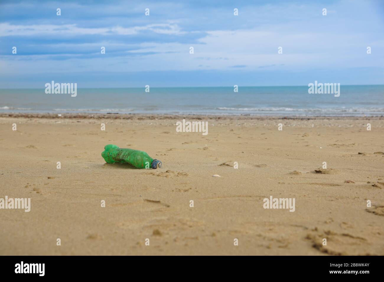 Waste plastic bottle on sand. Garbage on the beach Stock Photo - Alamy