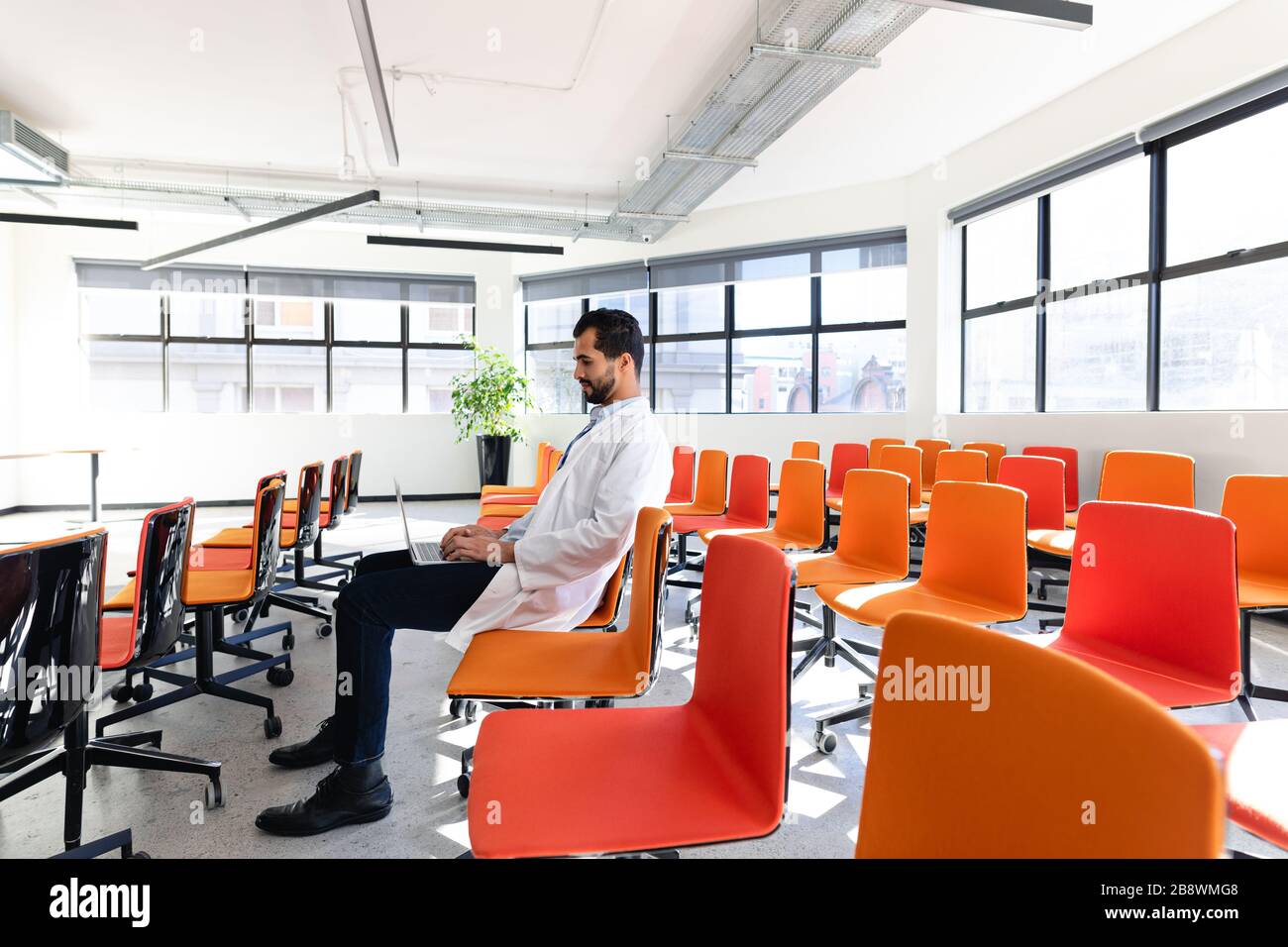 Doctor in a conference room using a laptop Stock Photo - Alamy