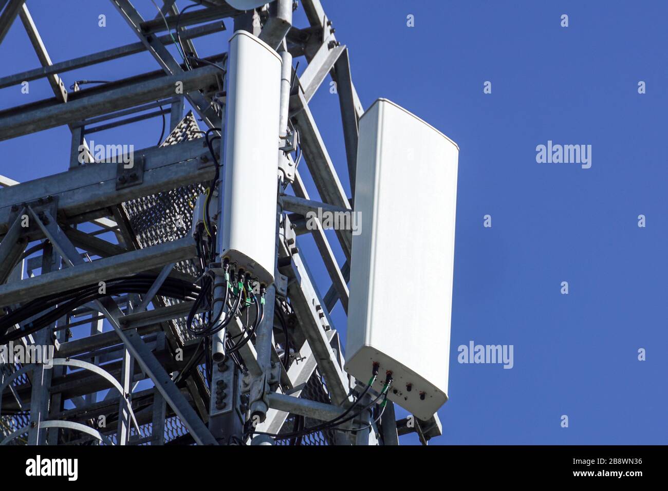 Close up white color antenna repeater tower on blue sky Stock Photo - Alamy