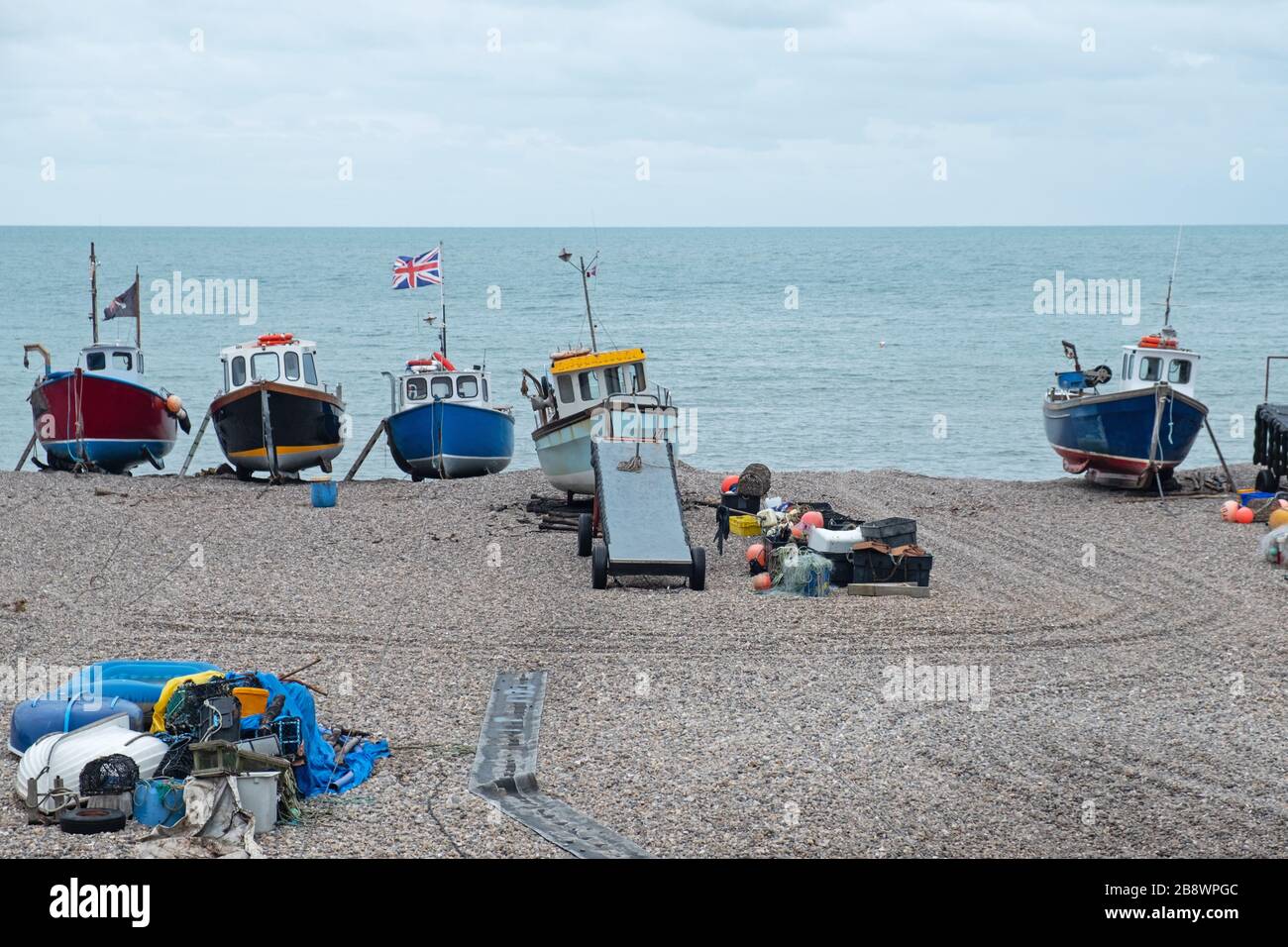 A part of the local fishing fleet stranded on the pebble beach at Beer ...