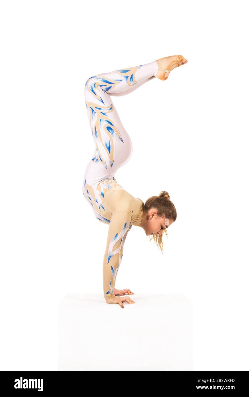Acrobat doing gymnastics, a young circus artist in a white and blue ...
