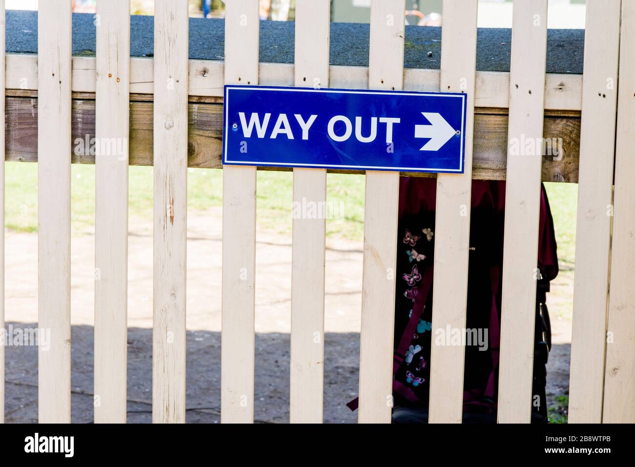 Way out sign with arrow hanging on a fence Stock Photo - Alamy