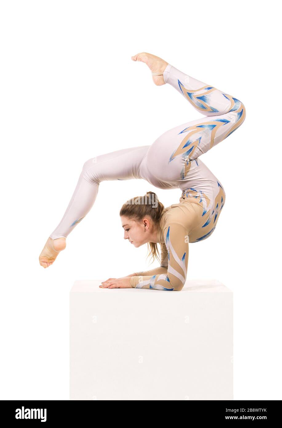 Acrobat doing gymnastics, a young circus artist in a white and blue ...