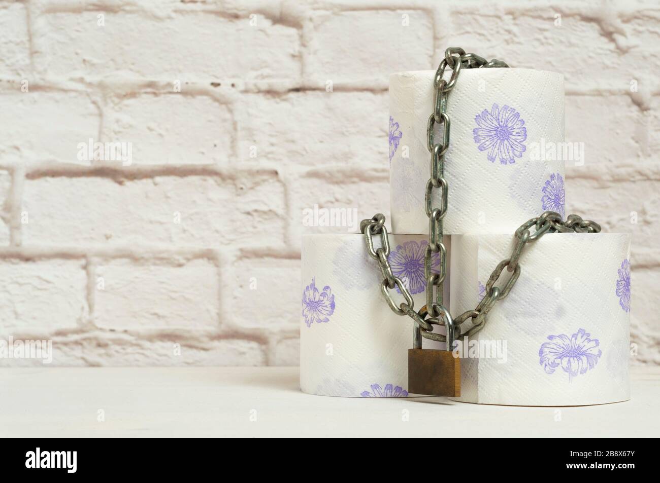 Rolls of toilet paper tied with a chain closed with a padlock Stock ...