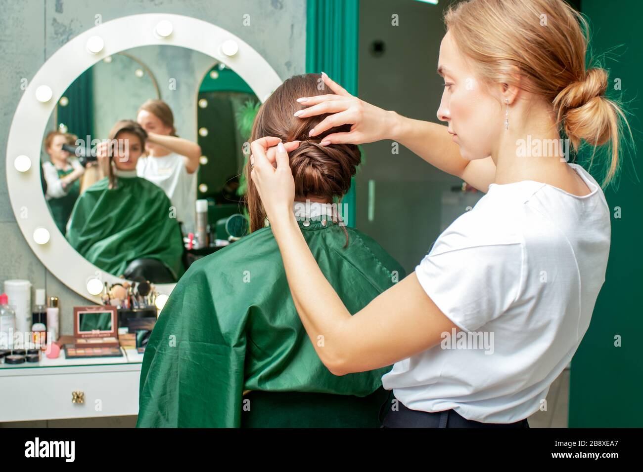 Professional hairdresser makes hairstyle of woman in beauty salon Stock ...