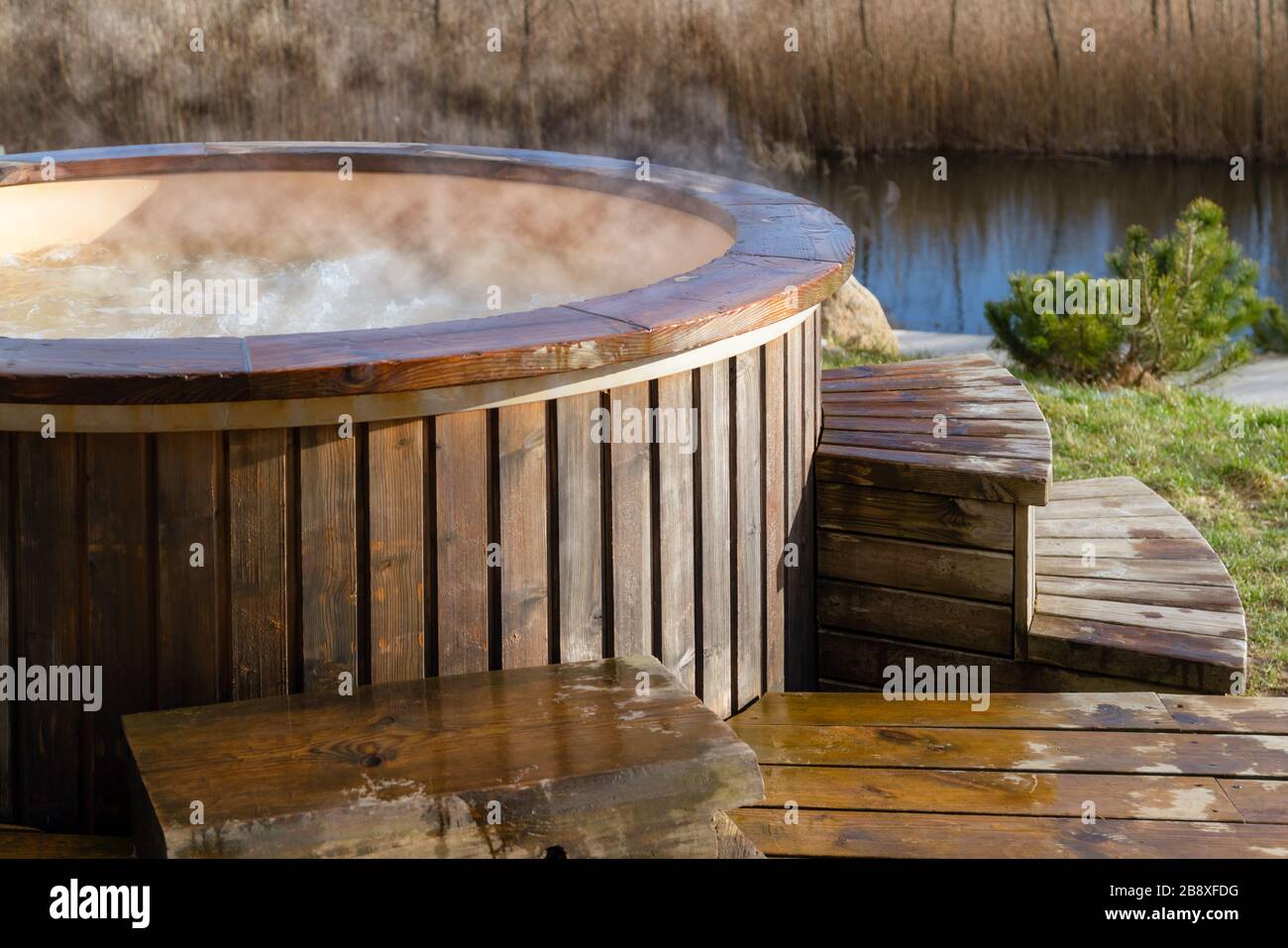 How water swirling in wooden hot tub outside in nature. Enjoying hot ...
