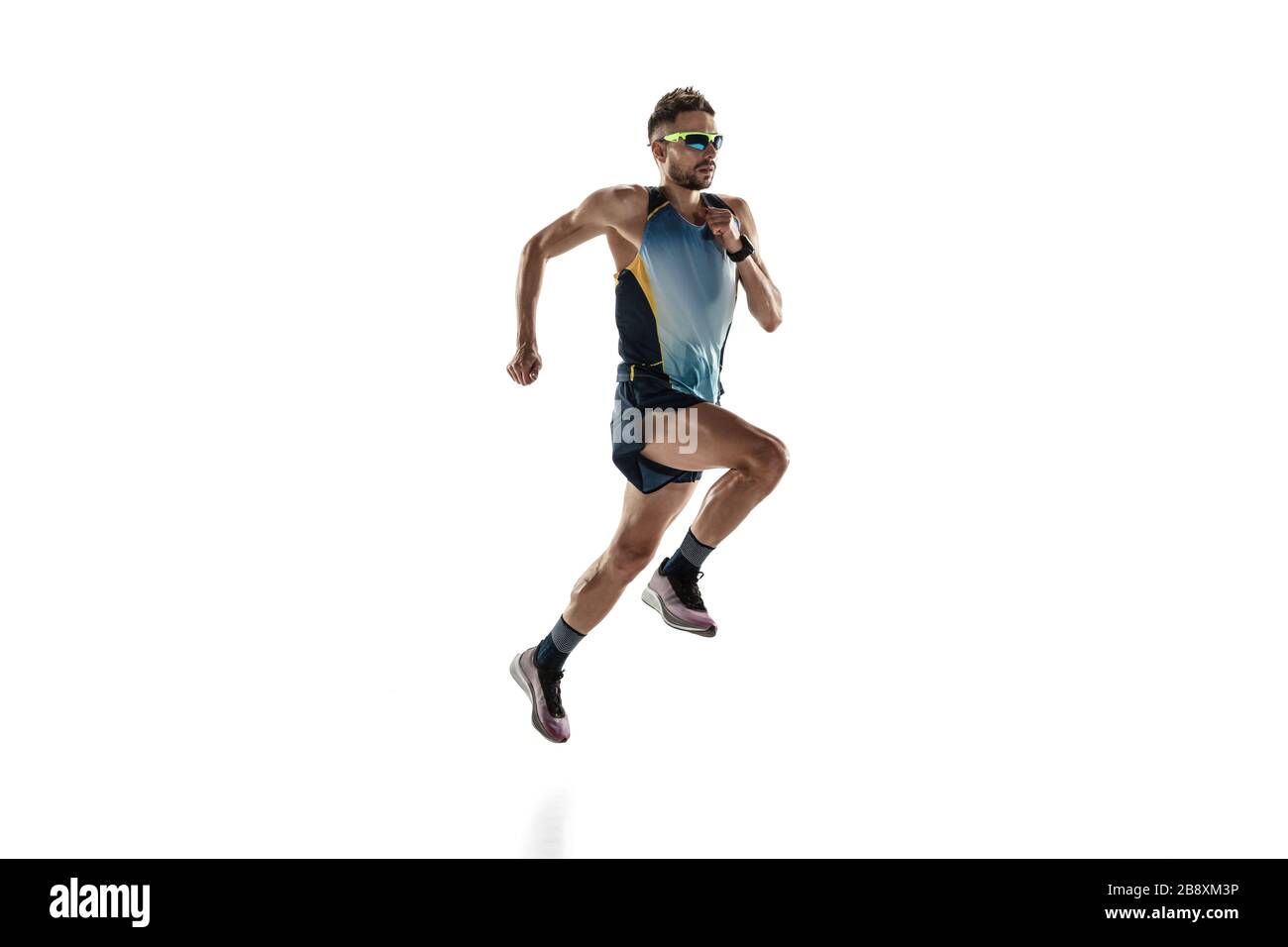 Triathlon male athlete running isolated on white studio background ...