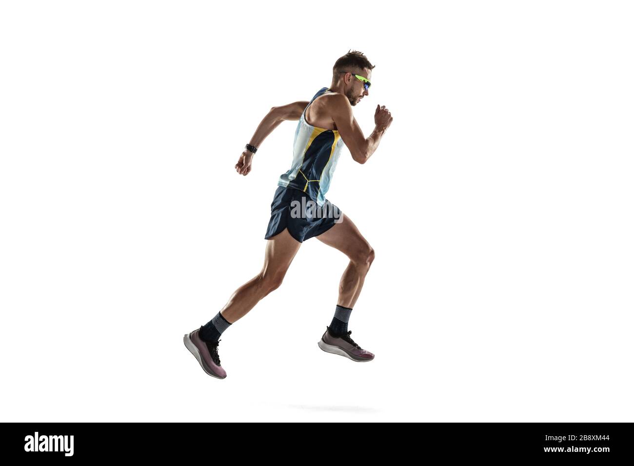 Triathlon male athlete running isolated on white studio background ...
