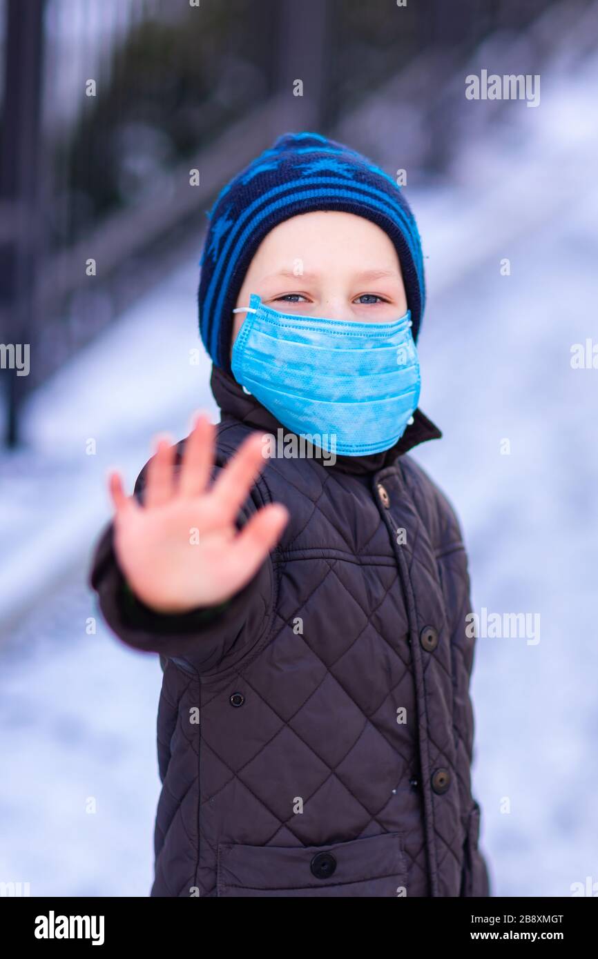 Young little boy wearing medical face masks to protect himself from ...