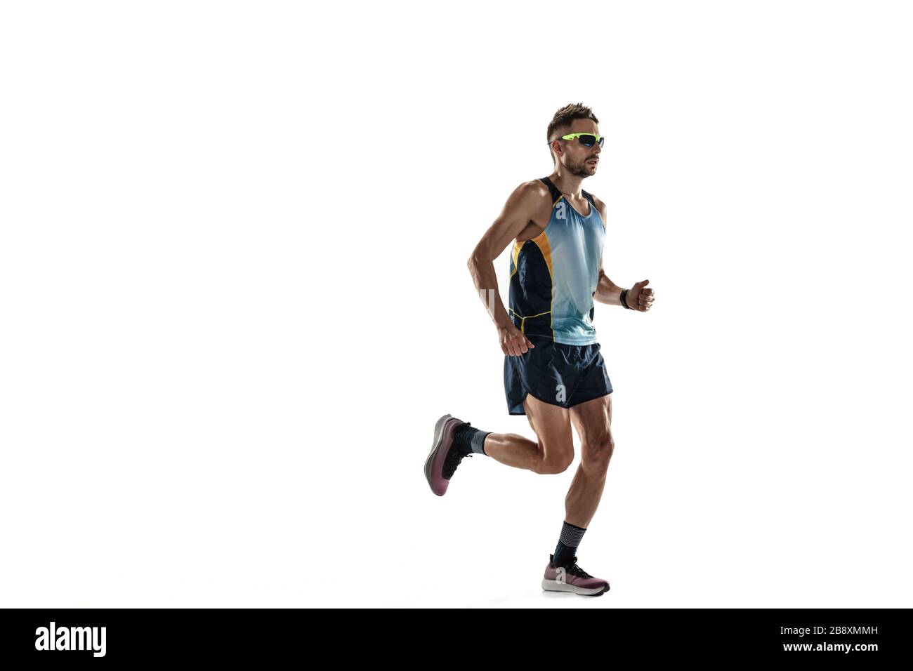 Triathlon male athlete running isolated on white studio background ...