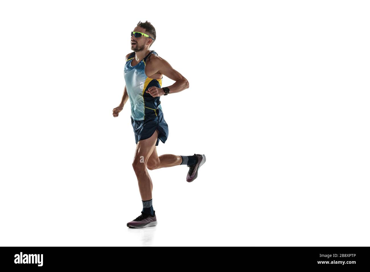 Triathlon male athlete running isolated on white studio background ...