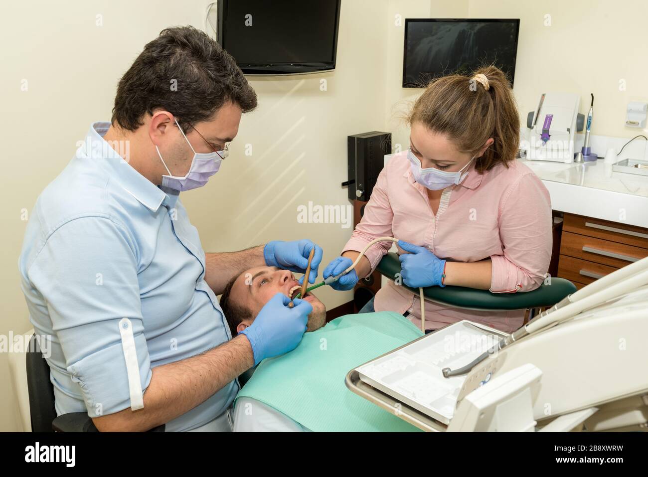 Dentist doing dental treatment hi-res stock photography and images - Alamy