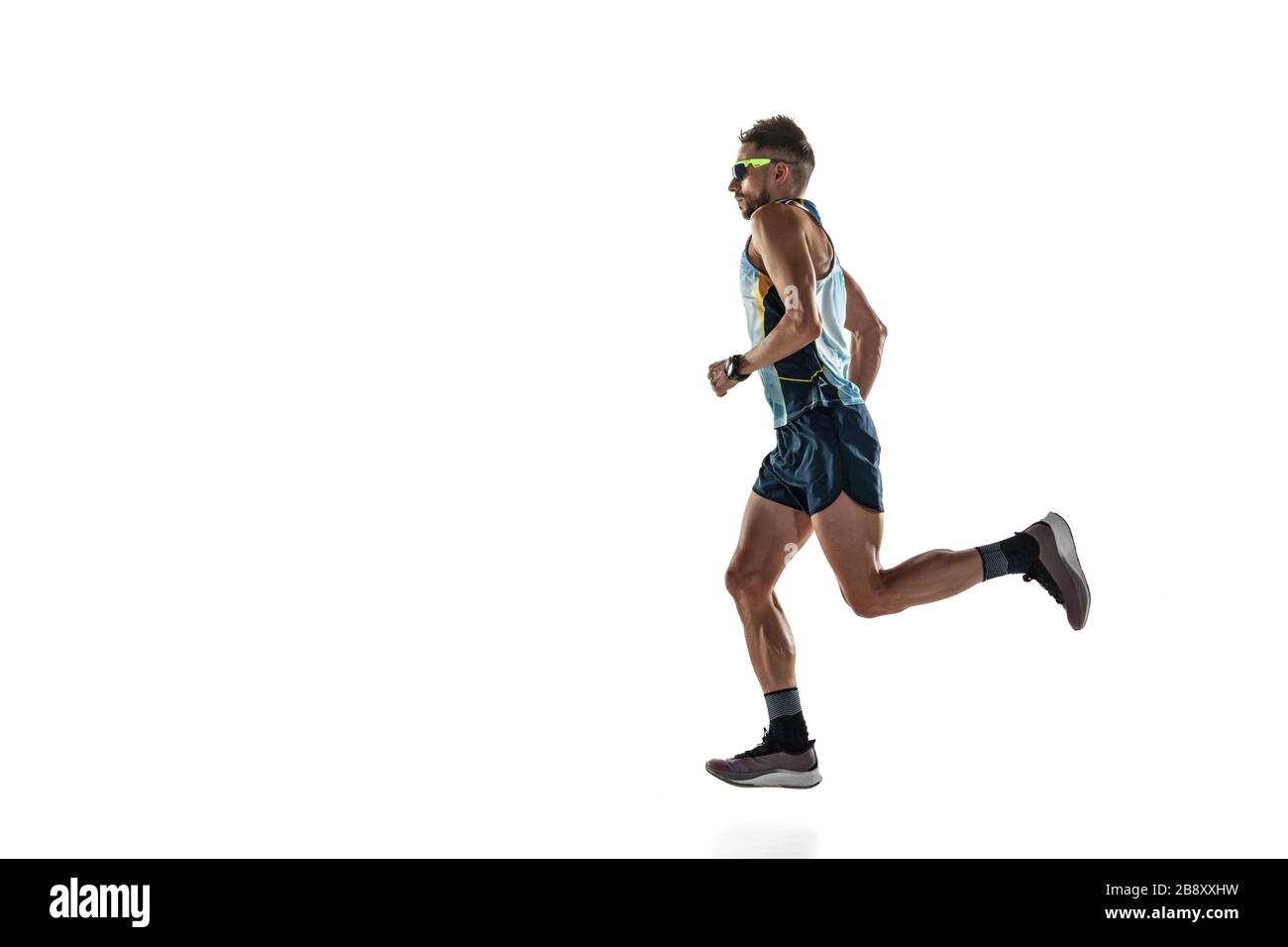 Triathlon male athlete running isolated on white studio background ...