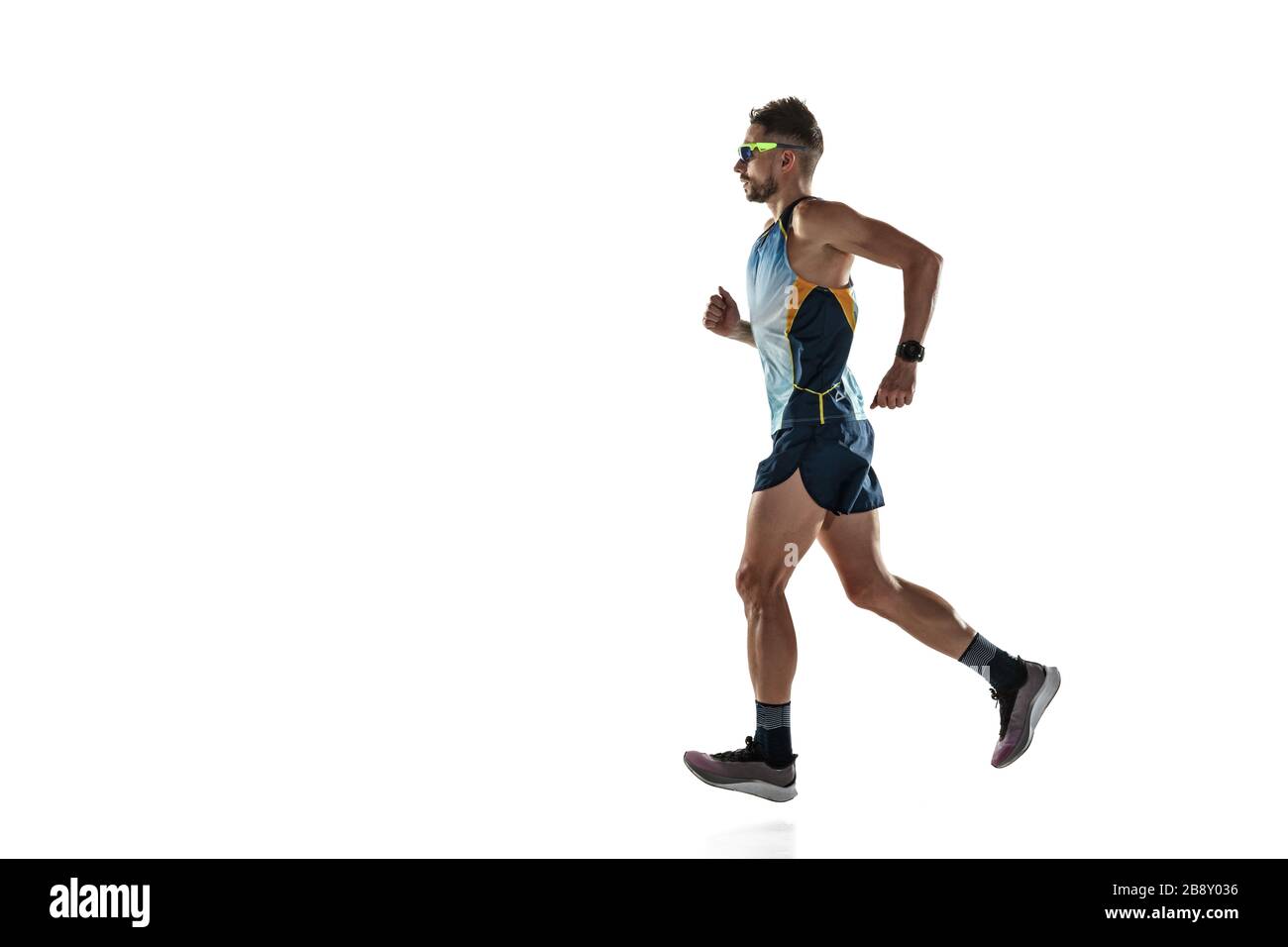 Triathlon male athlete running isolated on white studio background ...