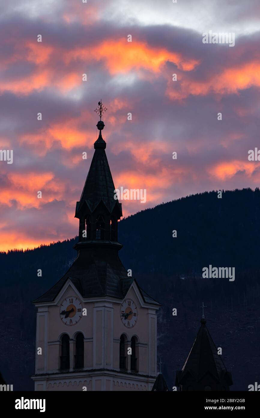 Church tower with clock with sunlit clouds in background Stock Photo ...