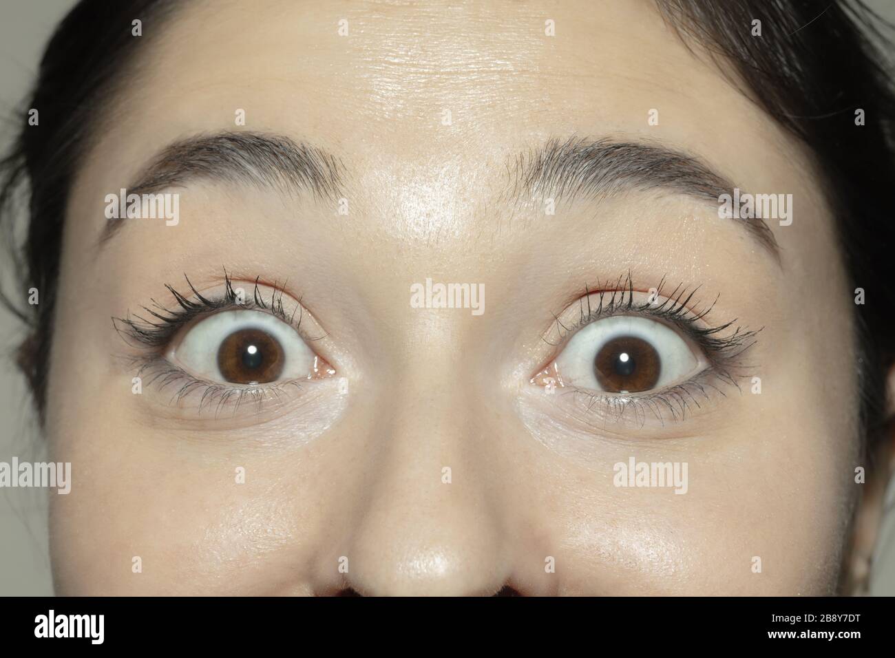 Shocked. Close up of face of beautiful caucasian young woman, focus on ...