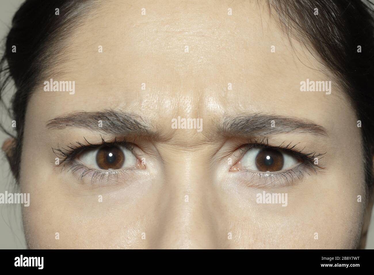 Angry. Close up of face of beautiful caucasian young woman, focus on ...