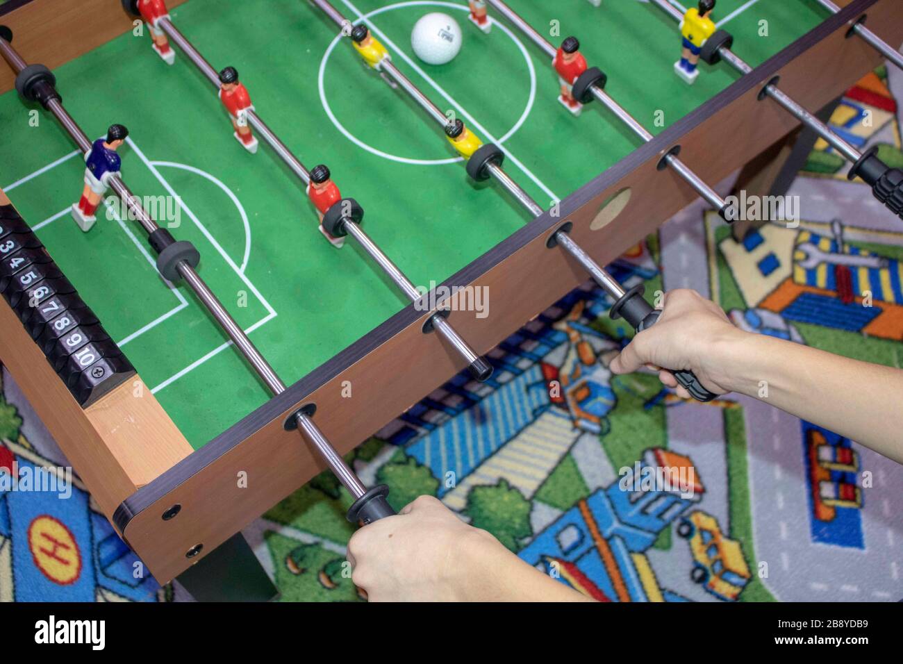 Boy playing soccer table game, kids hand Stock Photo - Alamy