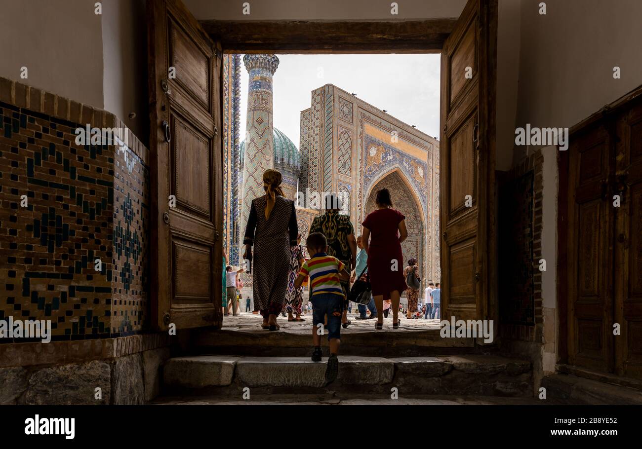 Samarqand, Uzbekistan - June 9, 2019: Tourists and boy at gate and door ...