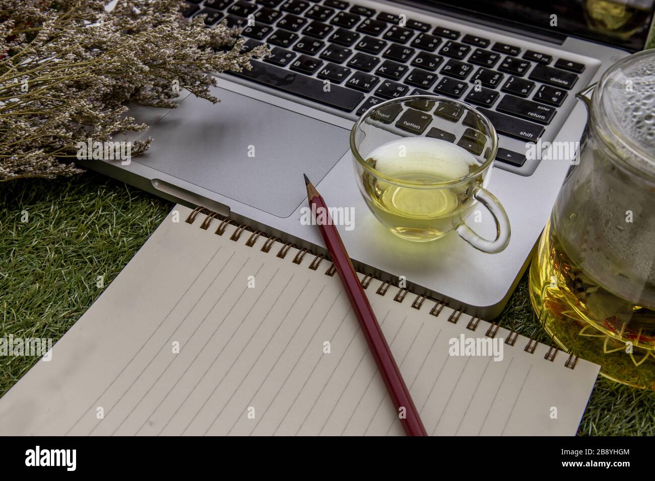 Relaxing time with a cup of tea. Workplace area with laptop, tea cup ...
