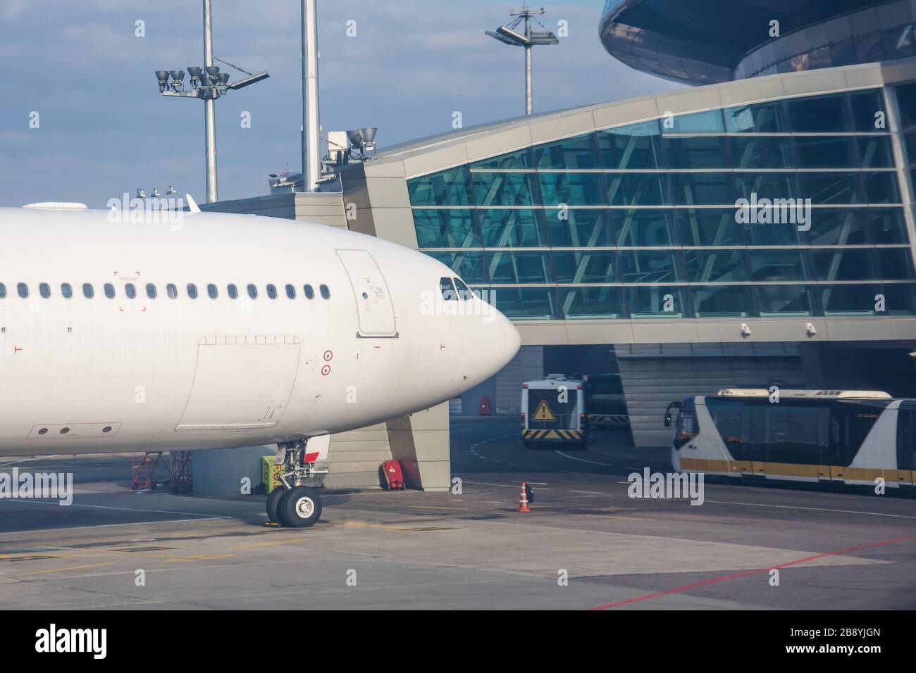The airplane stands at the passenger terminal building, nose cockpit ...
