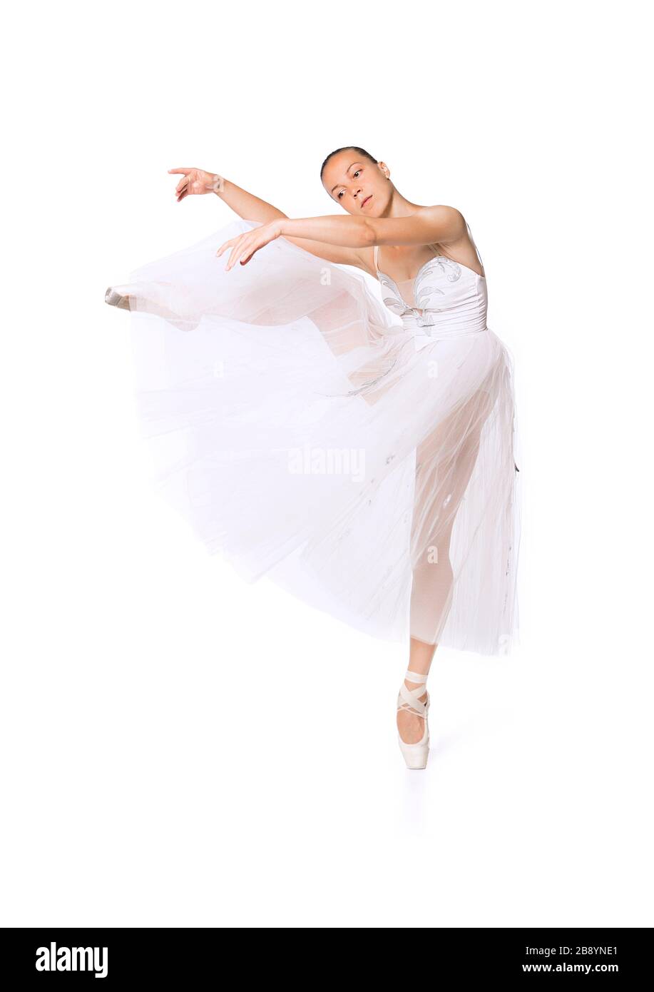 Slender woman in a white corset tutu dancing ballet. Studio shooting on ...