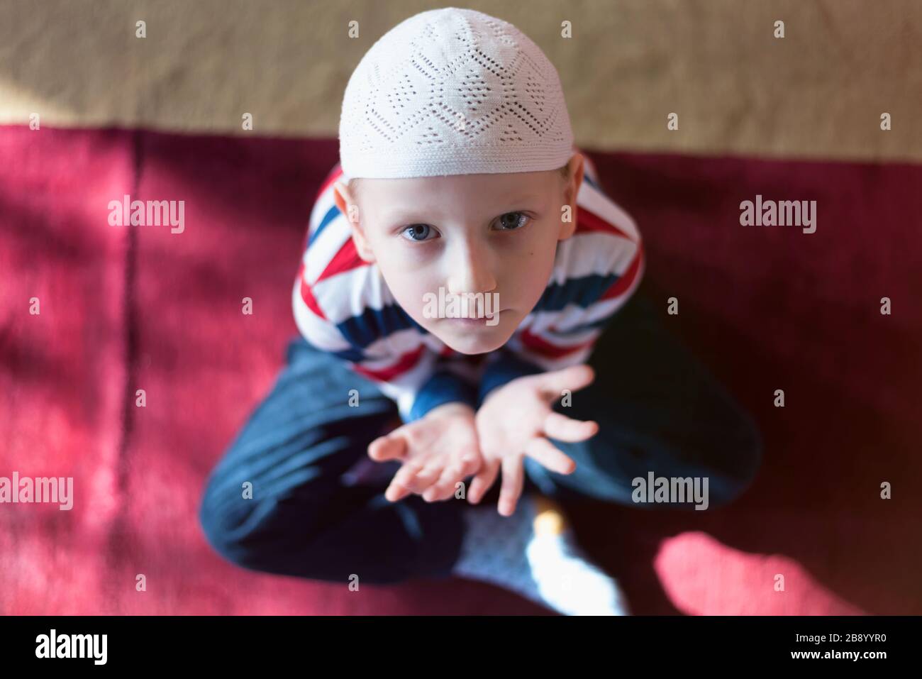 Ramadan Kareem,beautiful boy Muslim is praying in mosque,Peace and love ...